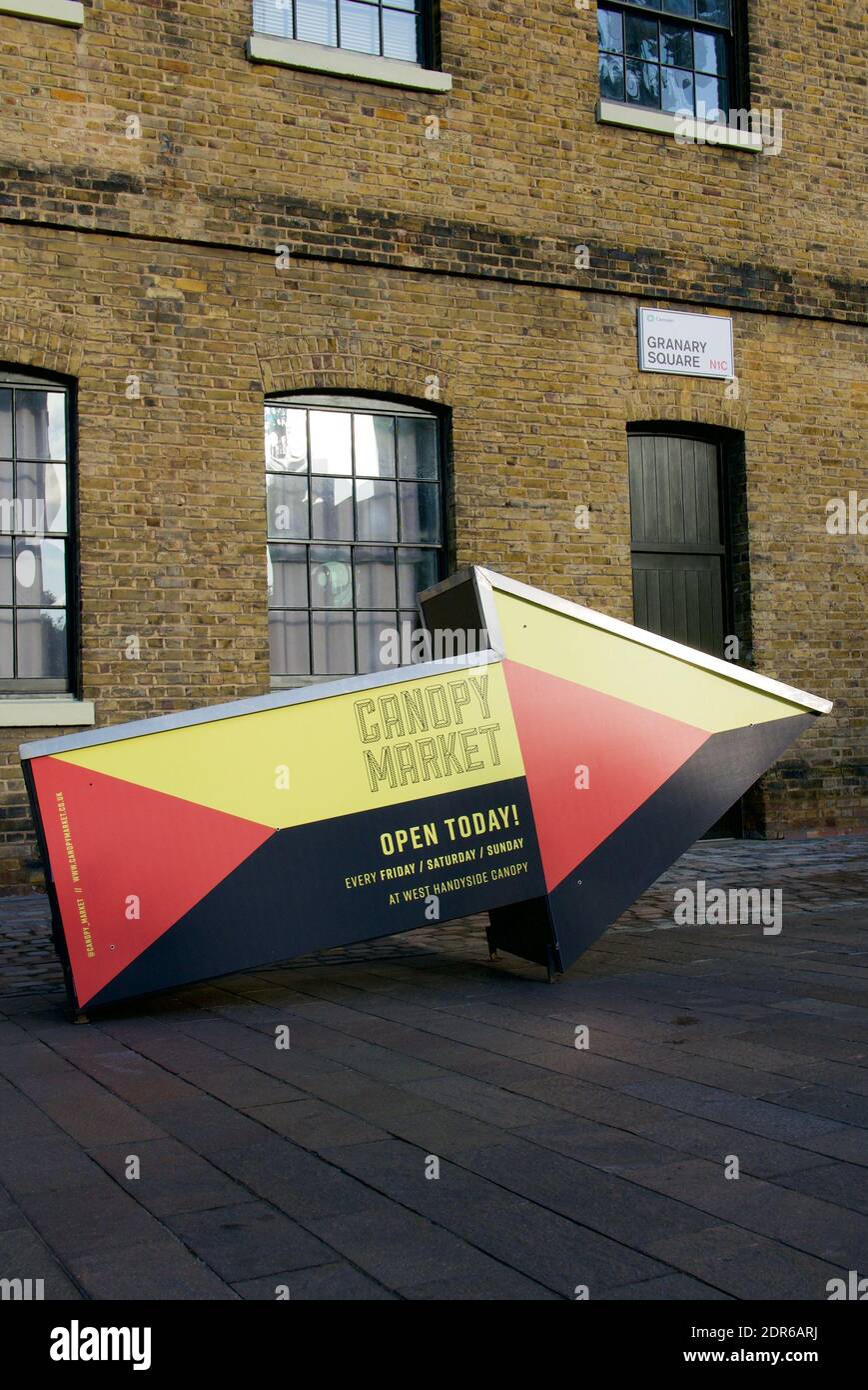 Canopy Market red, yellow and black arrow sign on Granary Square ...