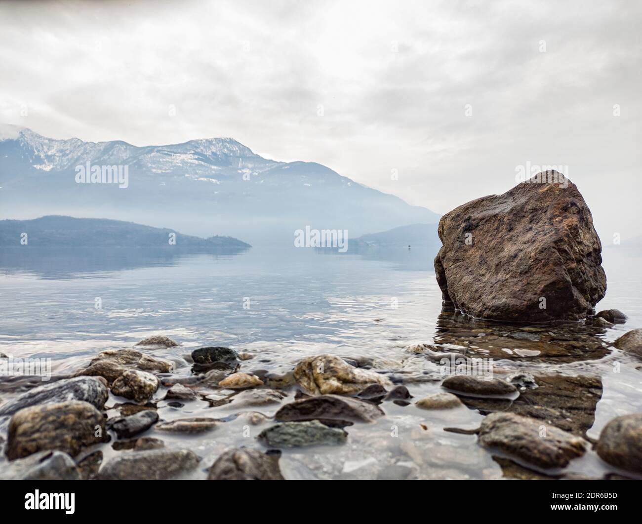Rock on the lakeside of Lake Como in winter Stock Photo - Alamy