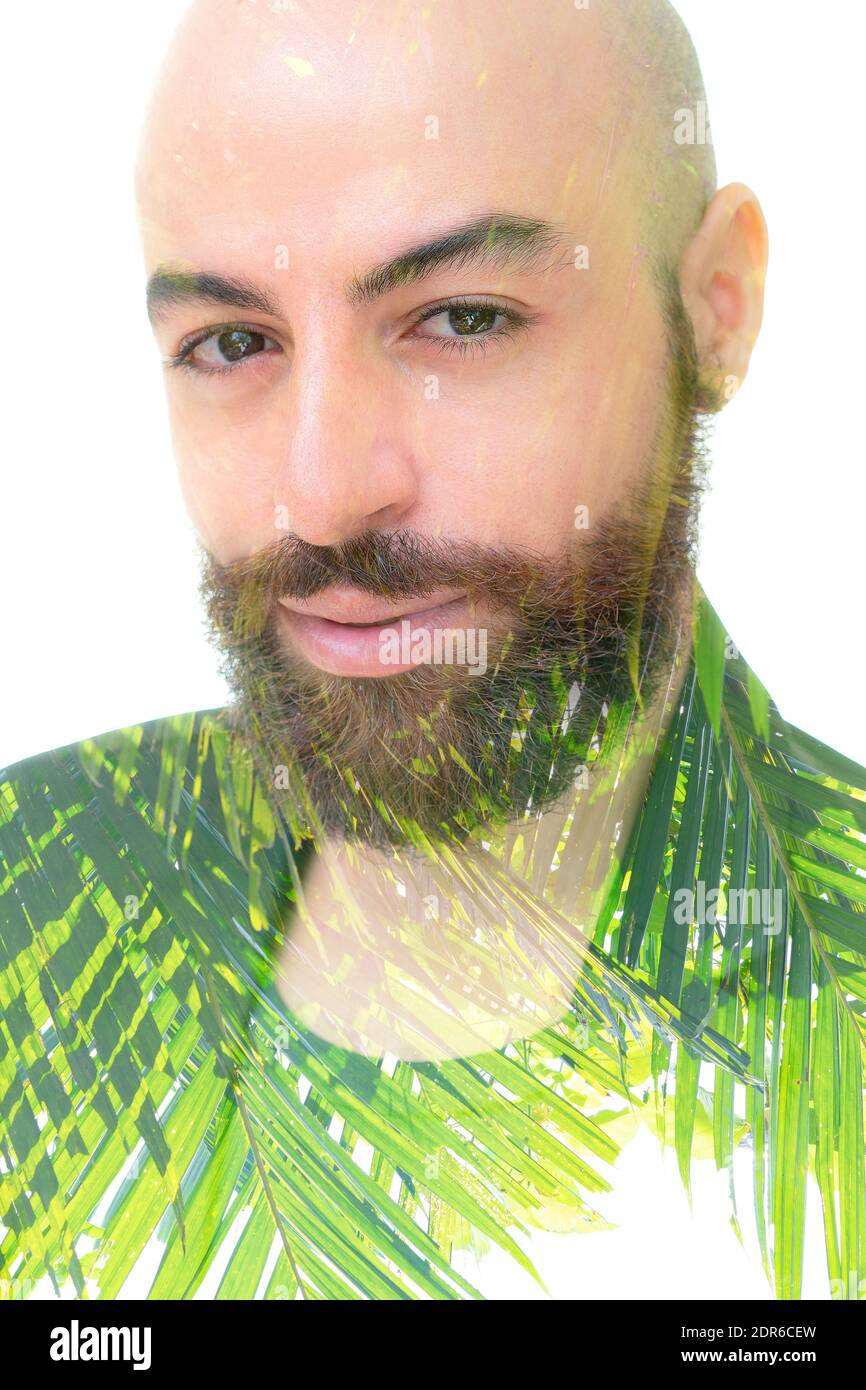 A smiling man's portrait combined with palm tree leaves Stock Photo - Alamy