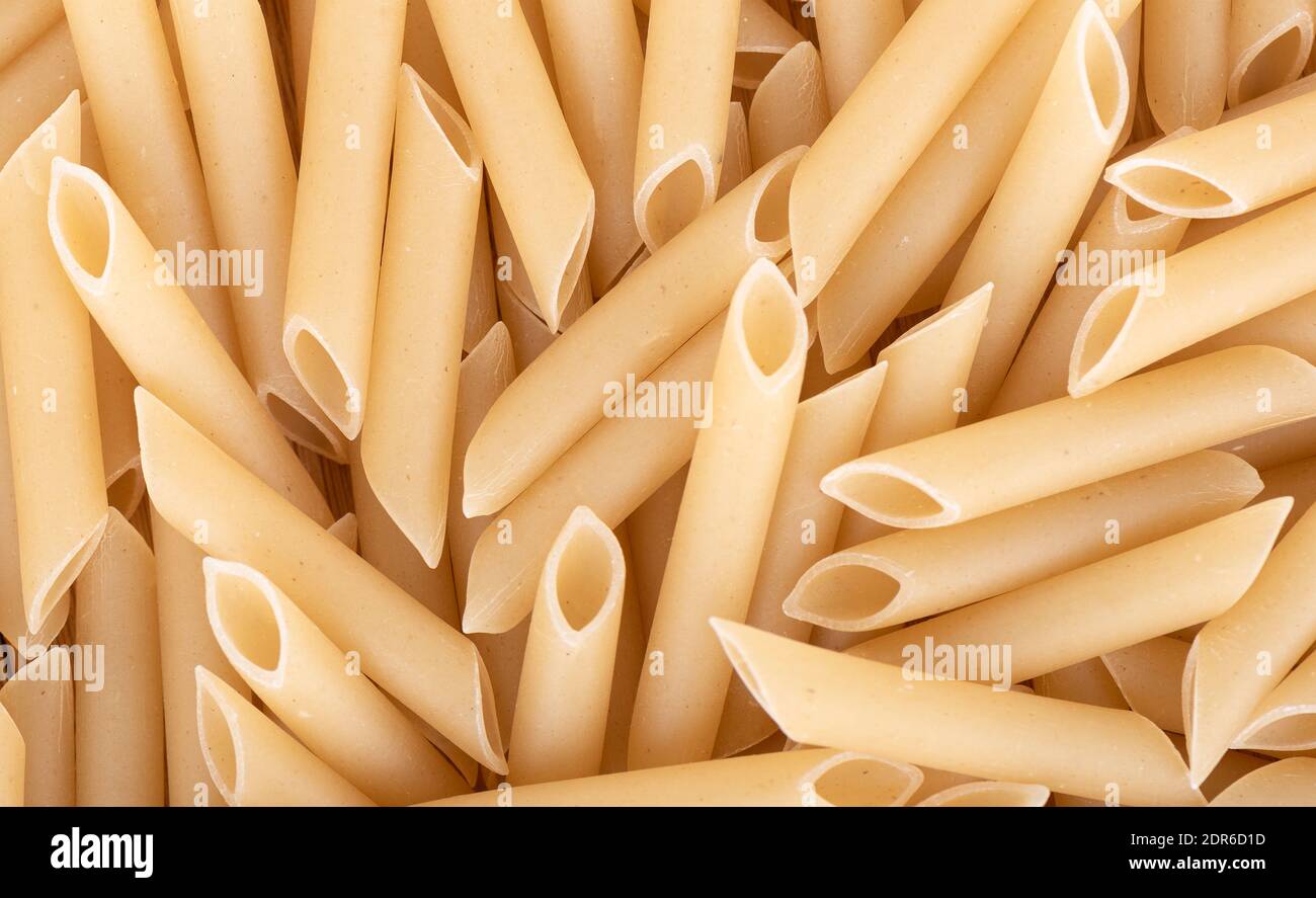 Full frame of uncooked straight pasta as background. Close up. Food ...