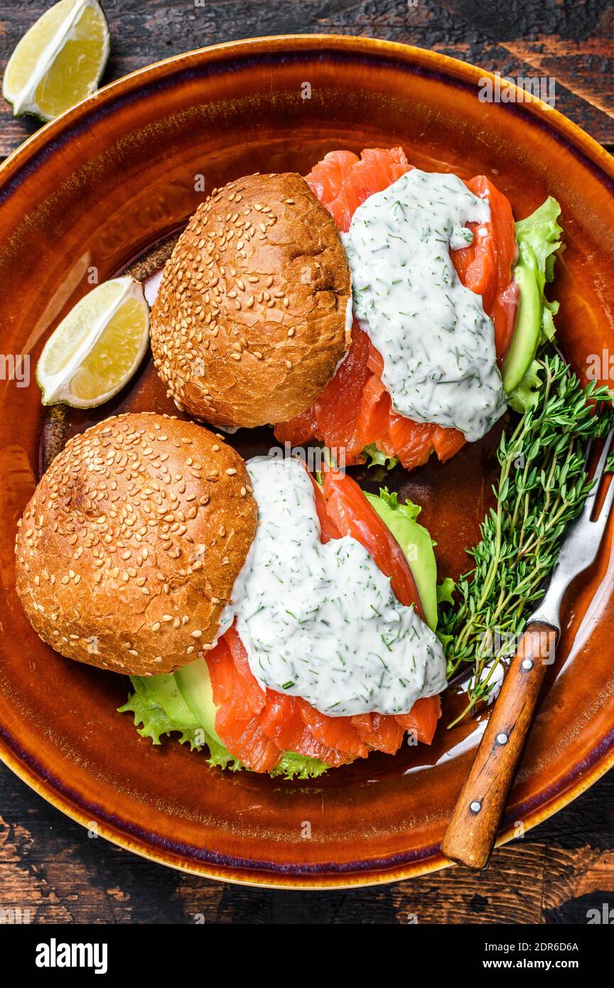 Fishburger with salted fish salmon, avocado, burger bun, mustard sauce ...