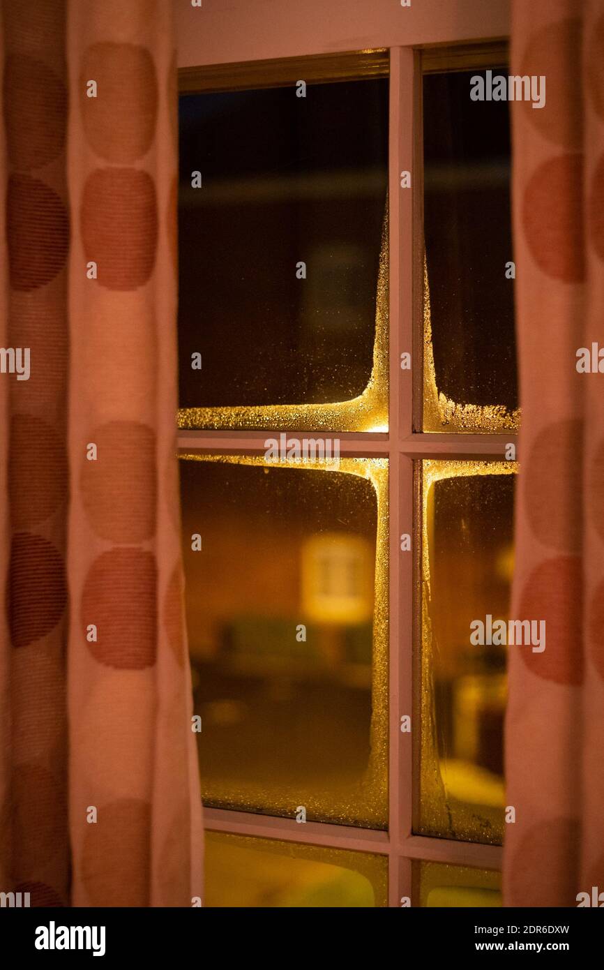 Condensation forming on the inside of the window of a UK house, flat ...