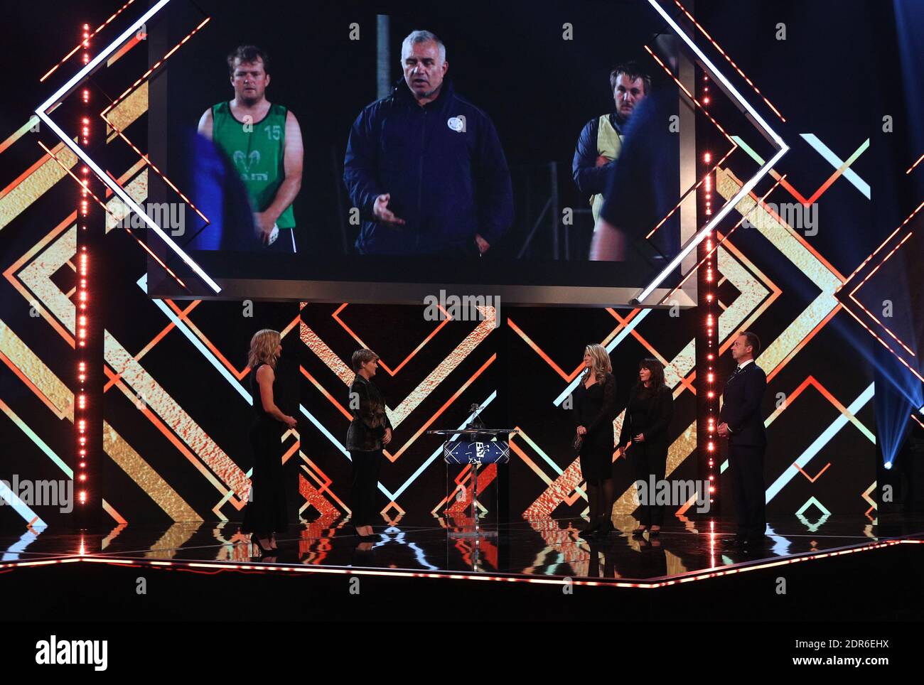 Sue Bushby (centre) receives the Unsung Hero award on behalf of her ...