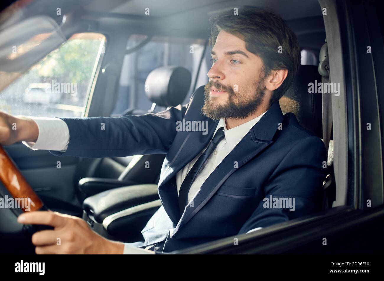business man in a suit driving a car trip road passenger Stock Photo ...