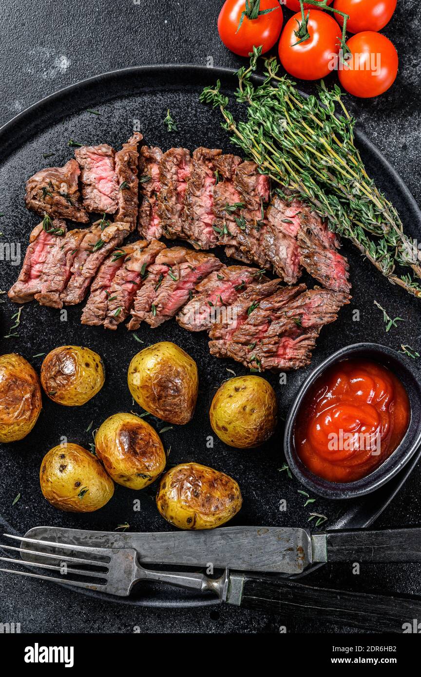 Grilled marble meat beef Steak with fried potato. Black background. Top ...