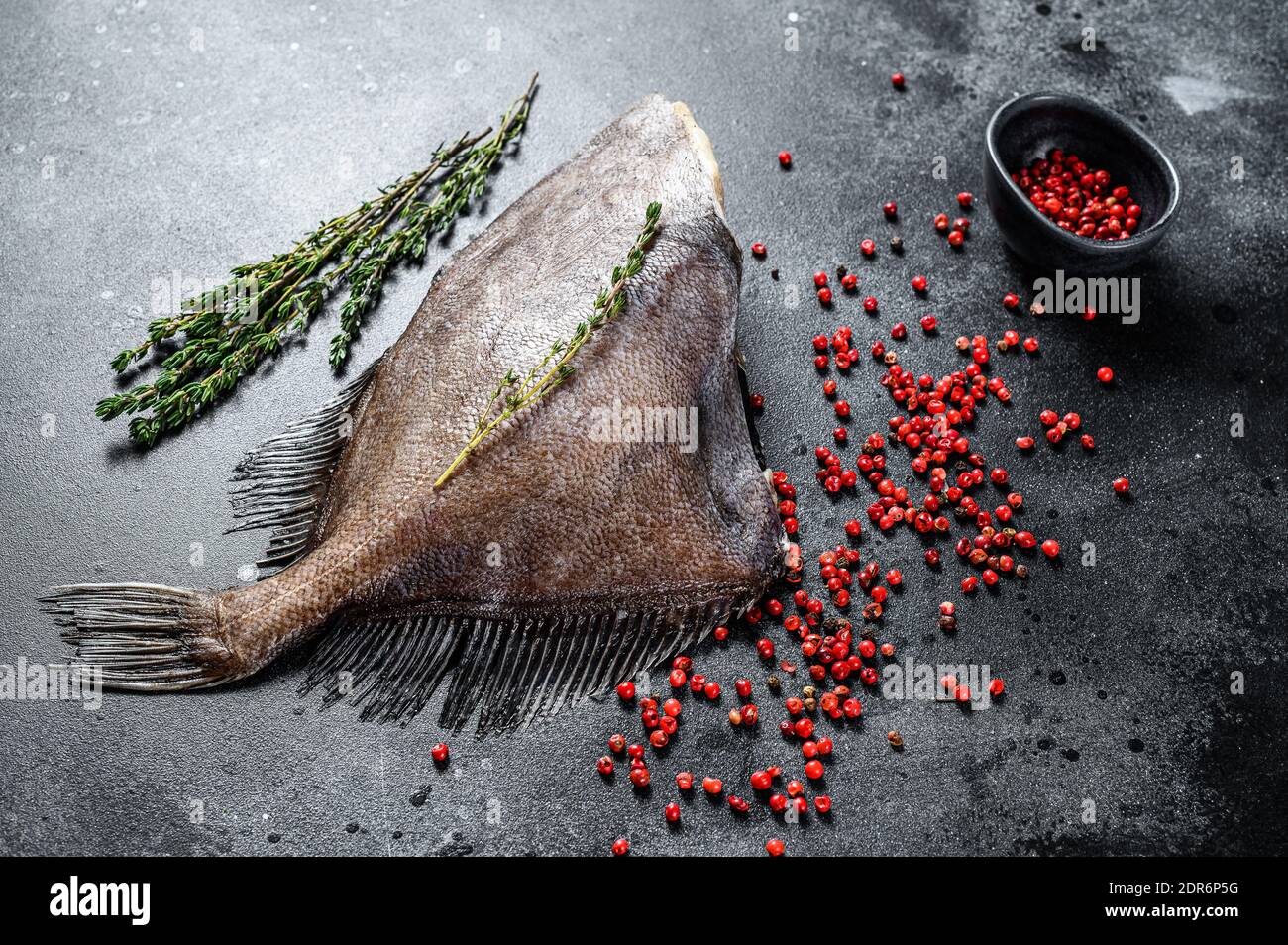 Raw fresh whole John Dory fish with spices and herbs for cooking. Black ...
