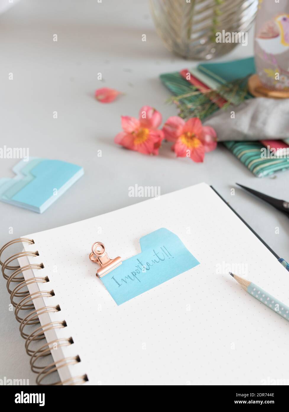 Empty spiral notebook with a dotted pencil and an important note ...