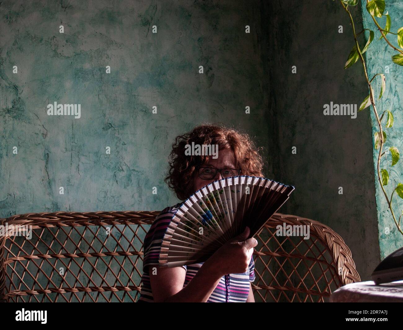 Woman covering face hand fan hi-res stock photography and images - Alamy