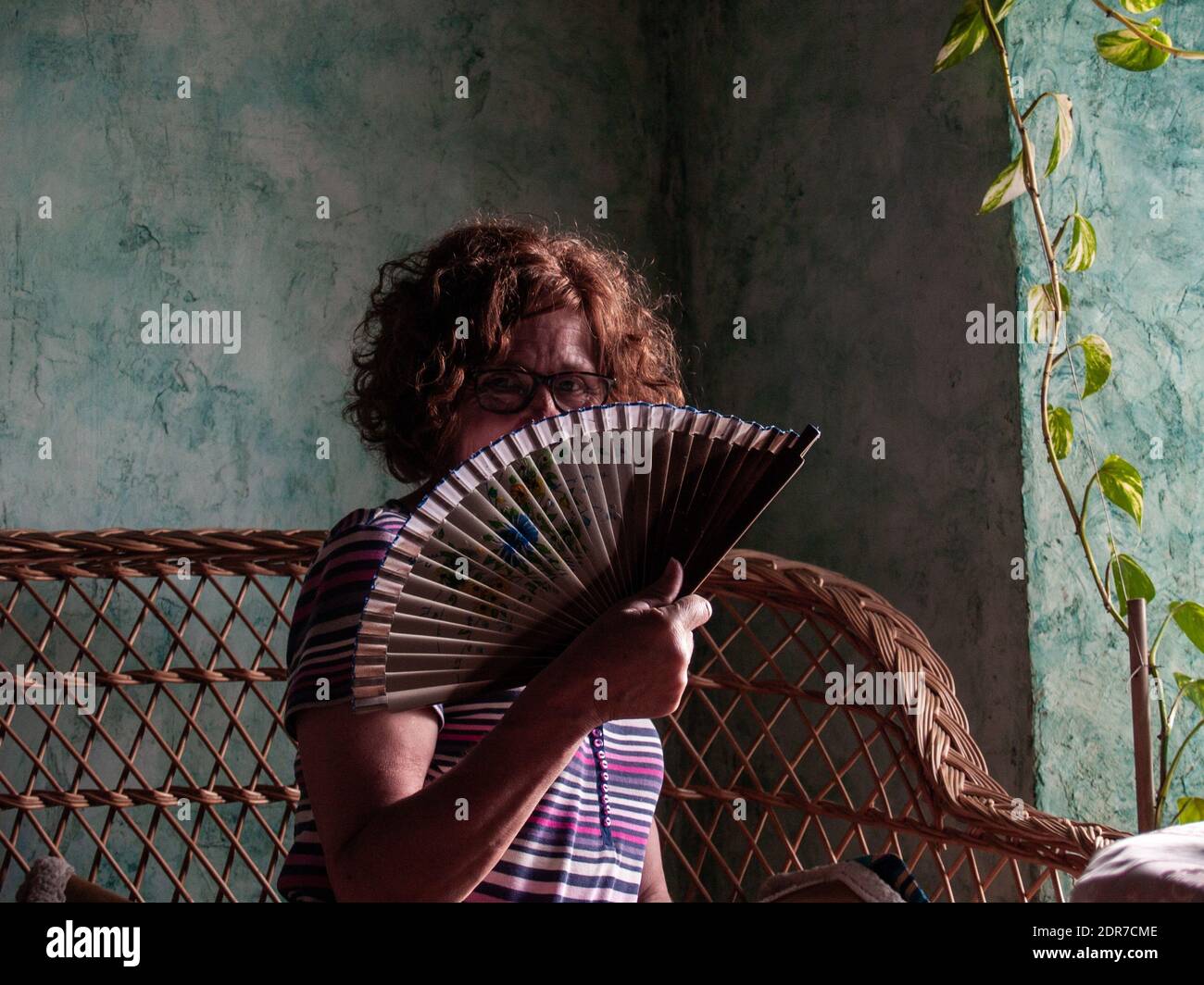 Woman covering face hand fan hi-res stock photography and images - Alamy