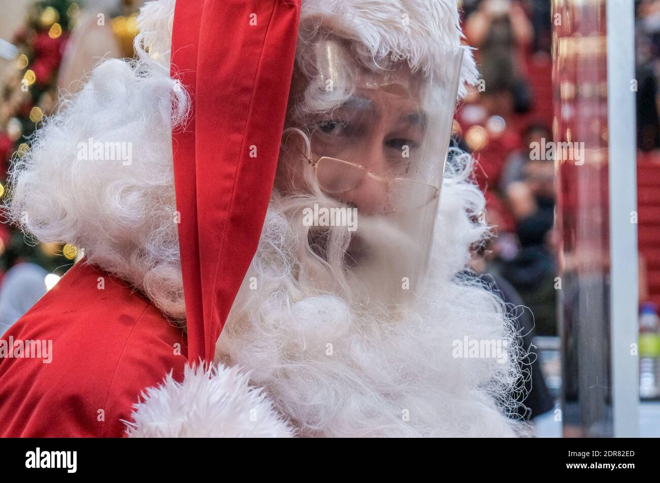 Santa Claus seen behind a protective shield at Pavillion shopping mall ...
