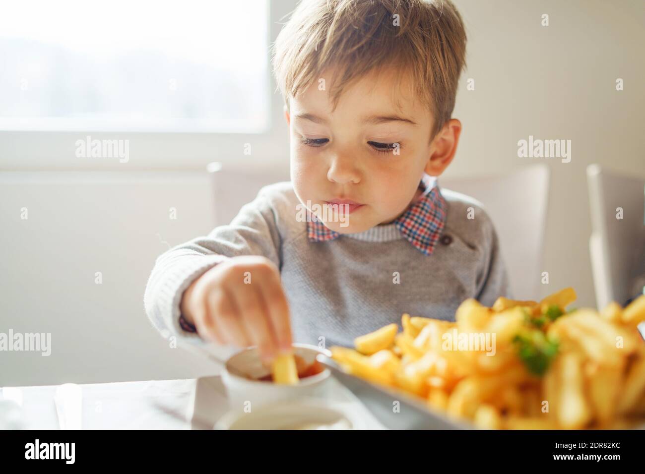 Boy 3 years eating at table hi-res stock photography and images - Alamy