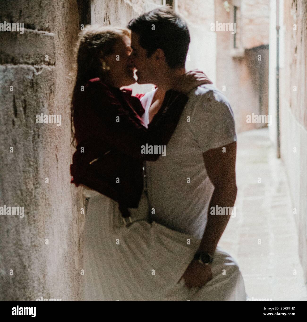 Young Couple Kissing Against Wall High Resolution Stock Photography and Images - Alamy