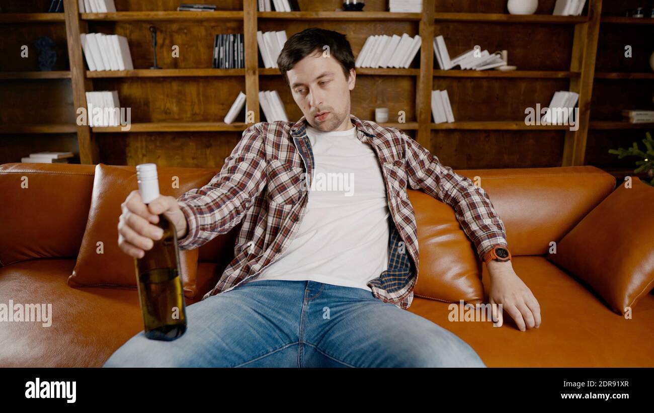 Alcohol addiction at young age. Caucasian male cannot stop drinking ...