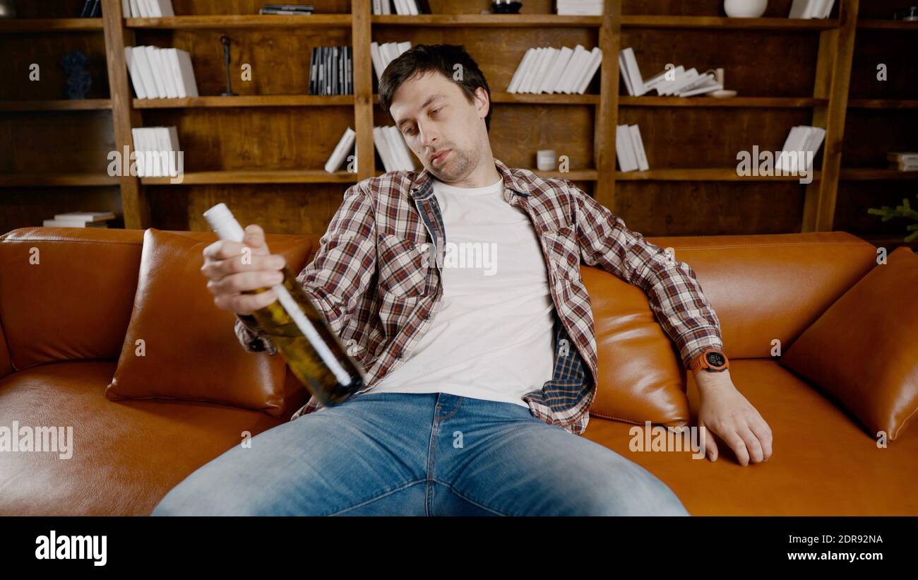 Alcohol addiction at young age. Caucasian male cannot stop drinking ...