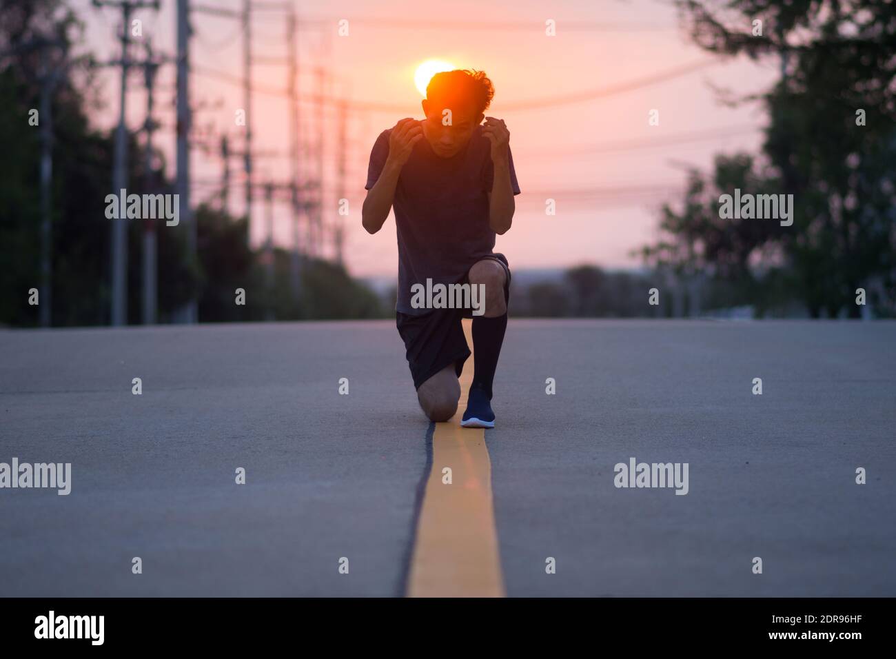 Man Running On Road At Sunset Stock Photo - Alamy
