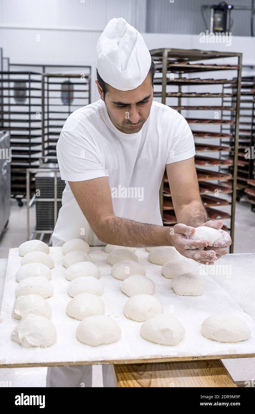 Baker Making Breads In Bakery Stock Photo - Alamy
