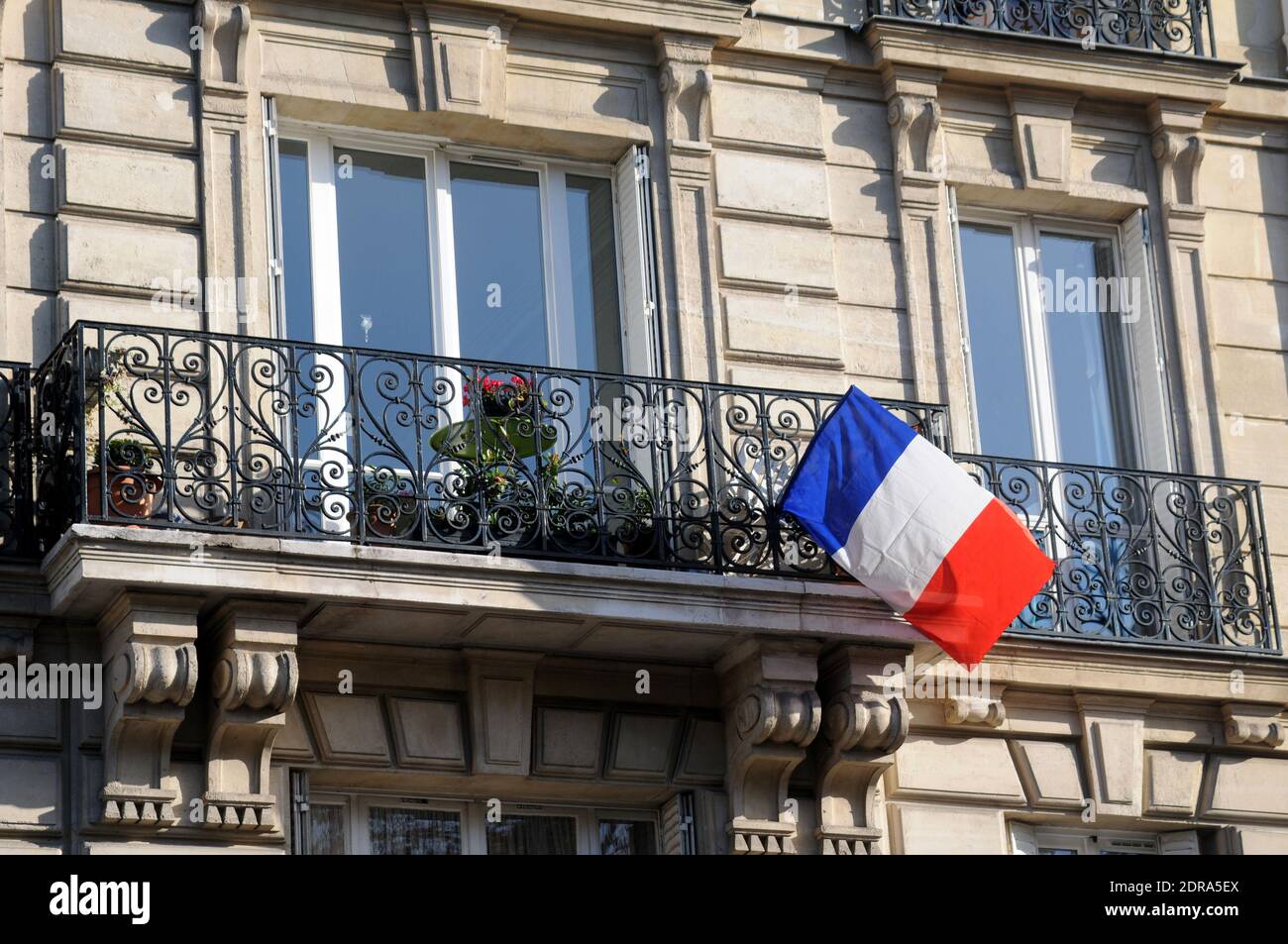 French flags hanging on the windows of Parisian people in Paris, France ...