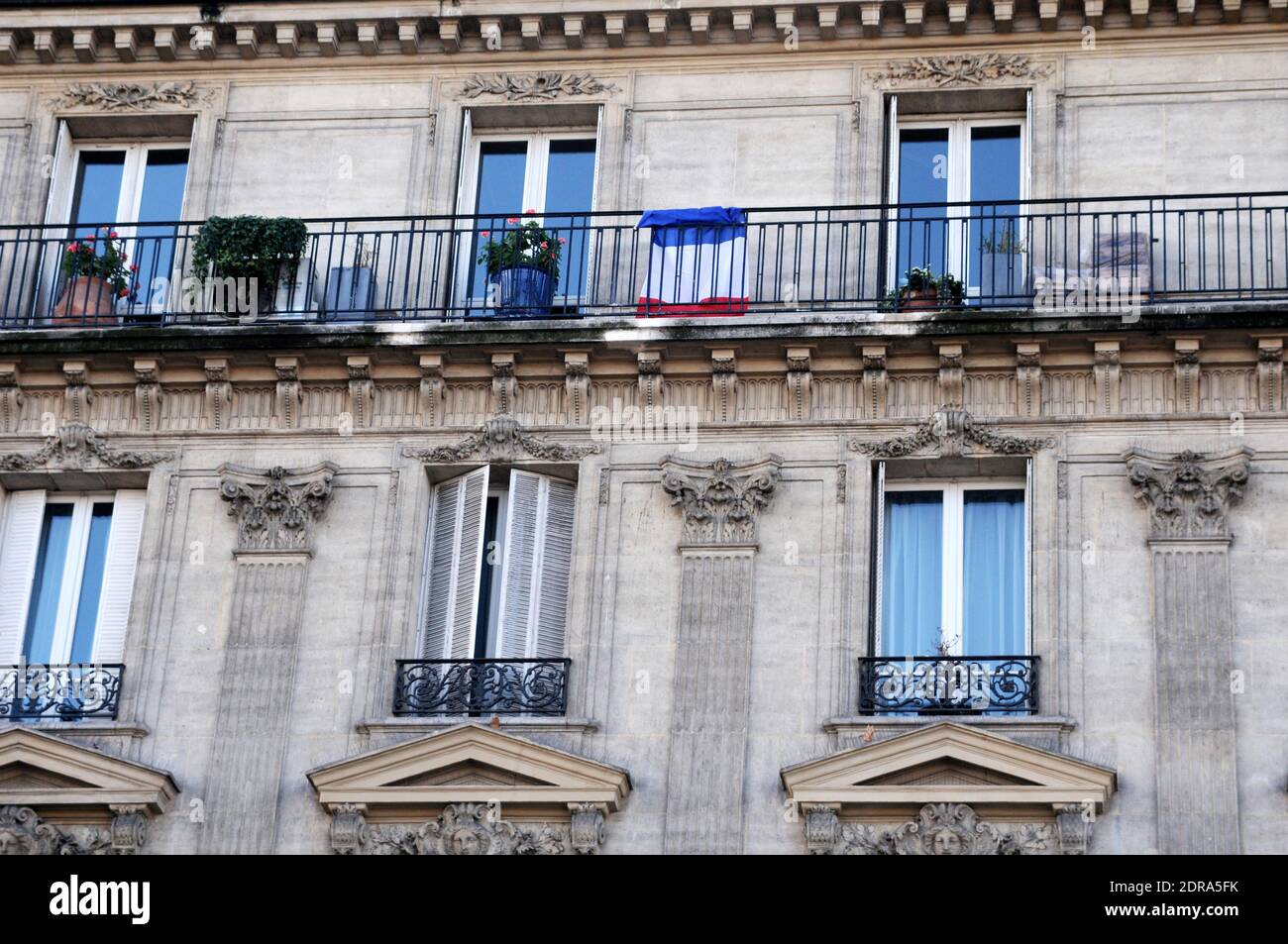 French flags hanging on the windows of Parisian people in Paris, France ...