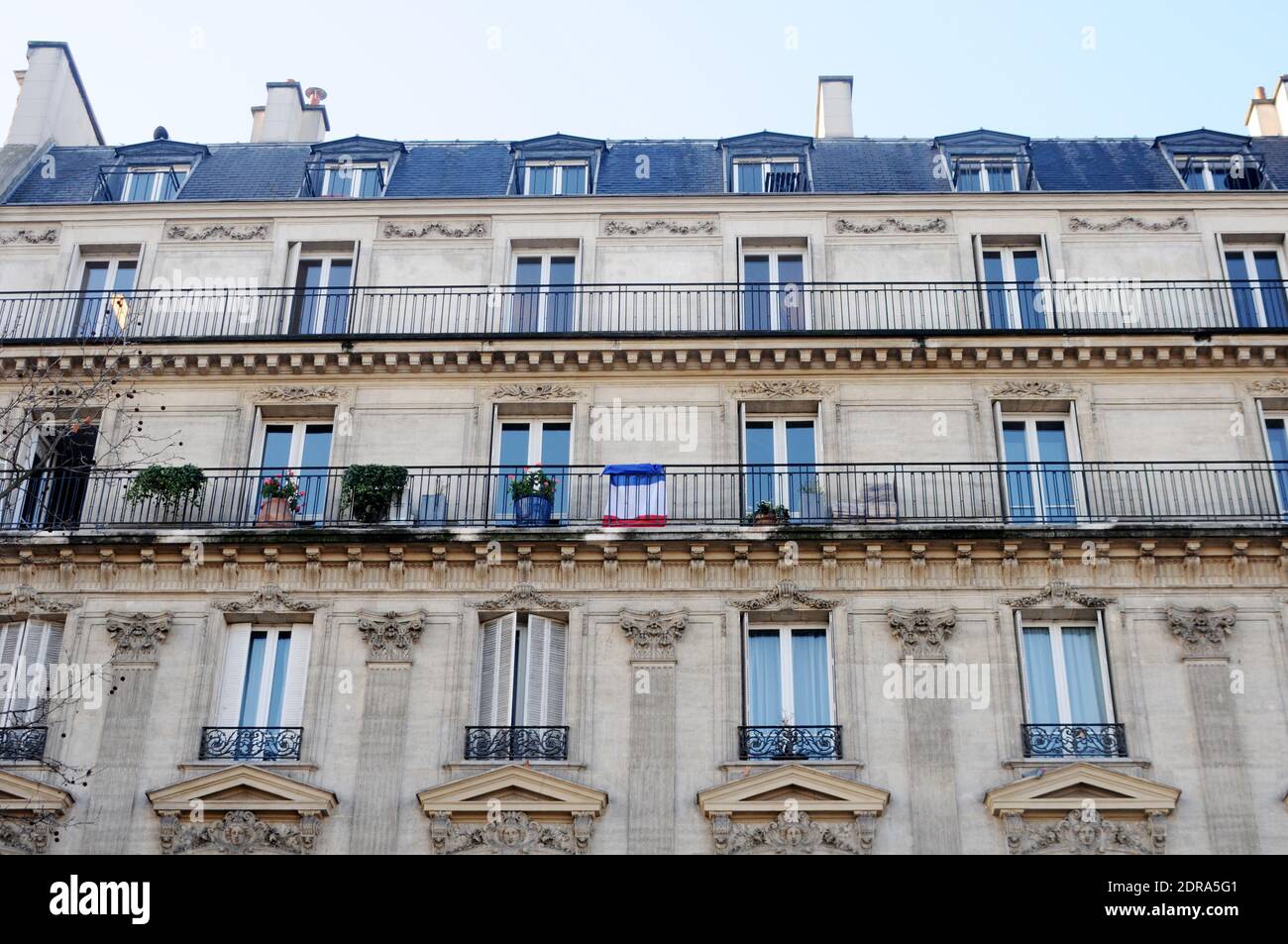 French flags hanging on the windows of Parisian people in Paris, France ...