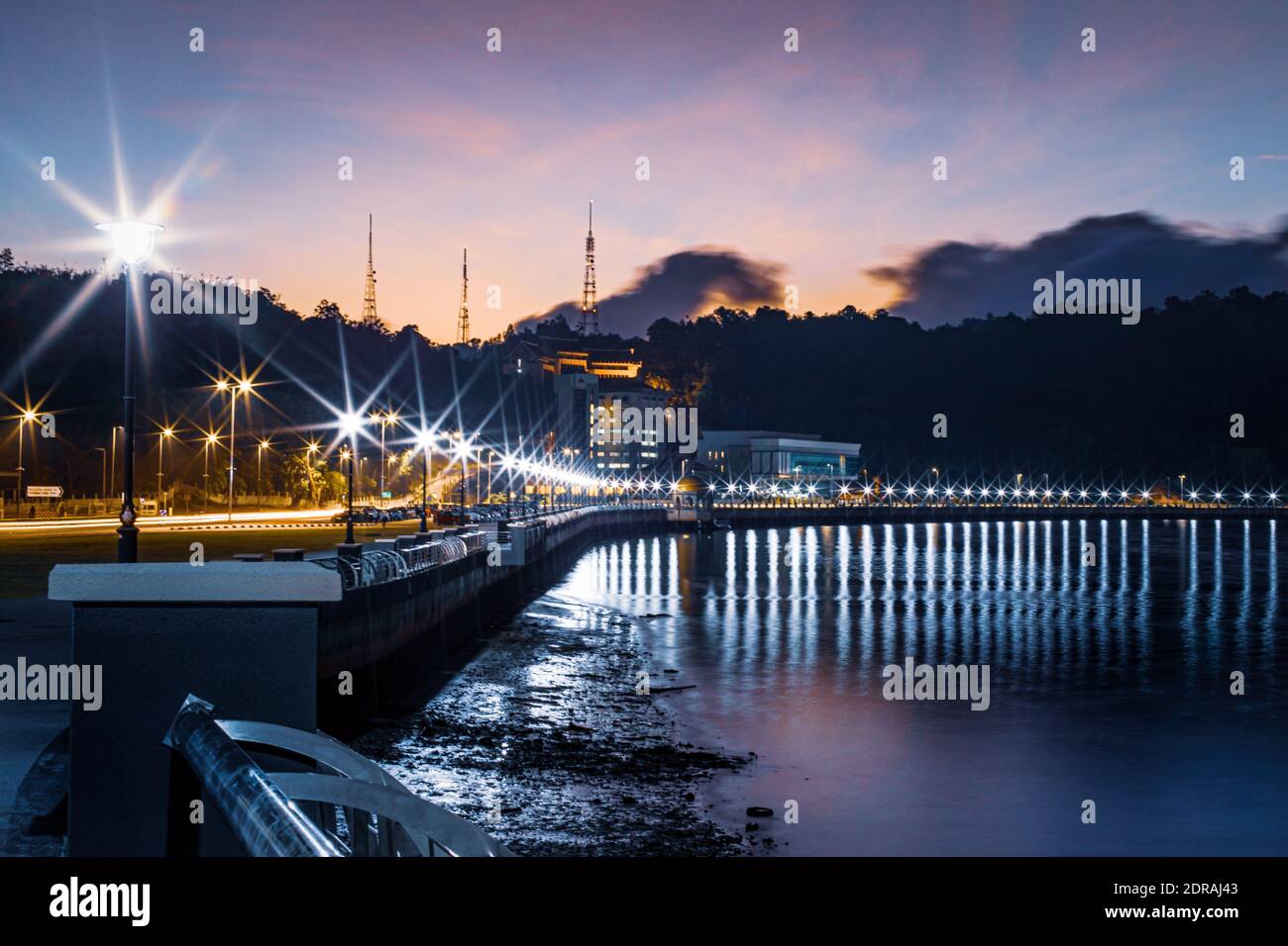 Illuminated Bridge Over Water At Night Stock Photo - Alamy