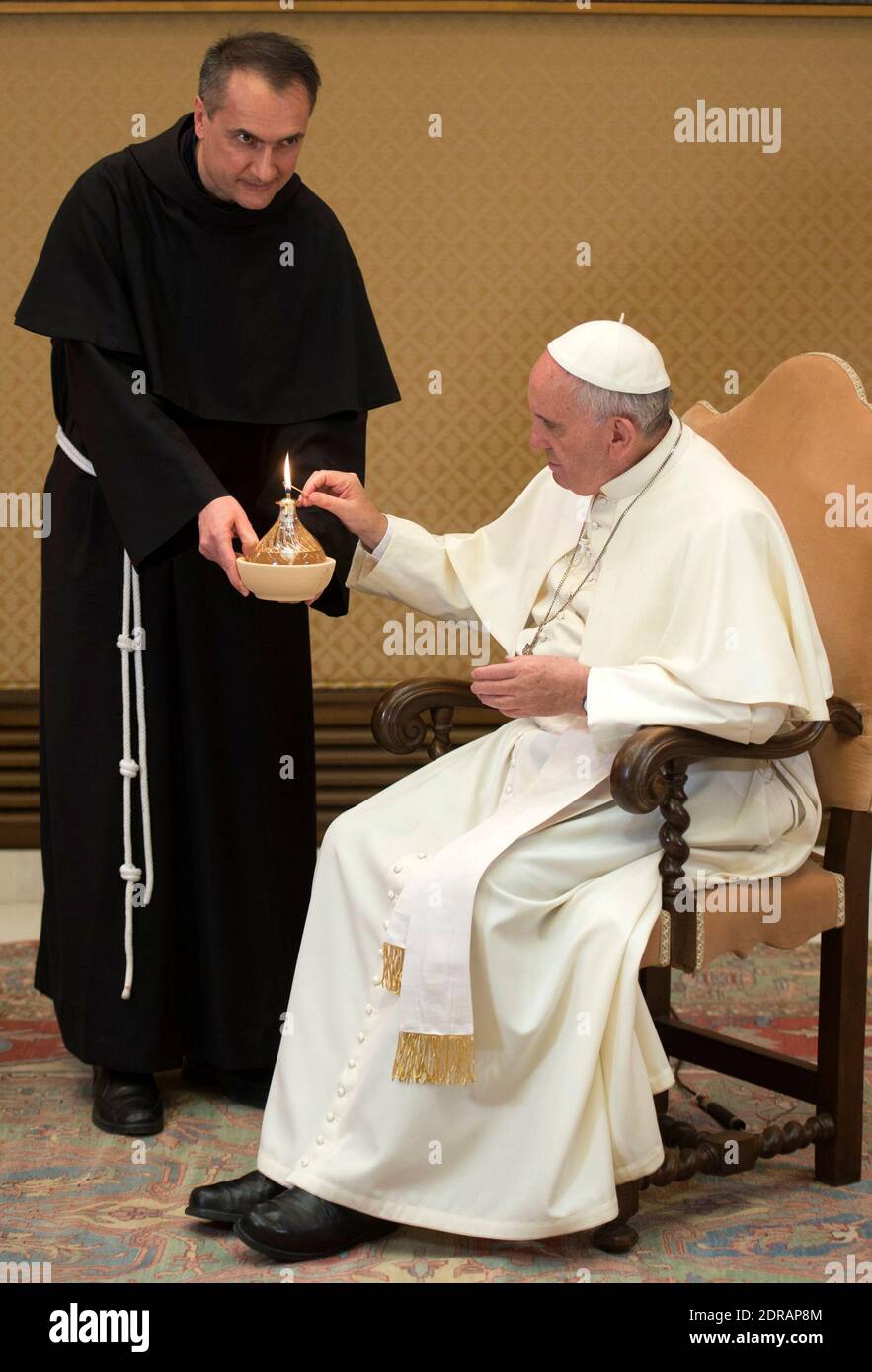 Pope Francis has lit a candle at the Vatican on Dec.6, 2015 to ...