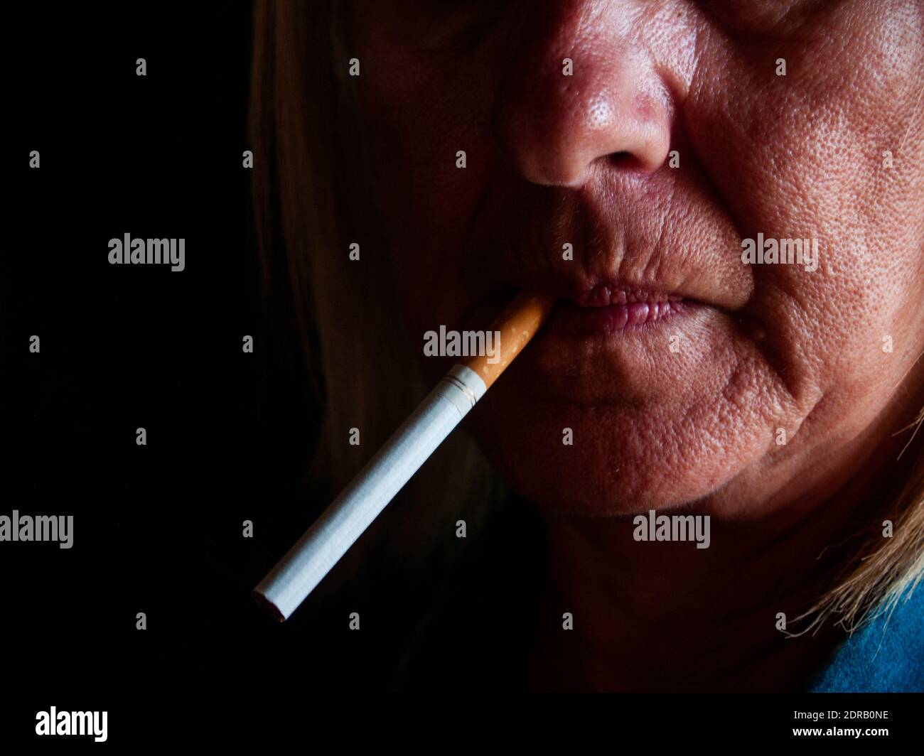 Mature woman smoking cigarette hi-res stock photography and images - Alamy
