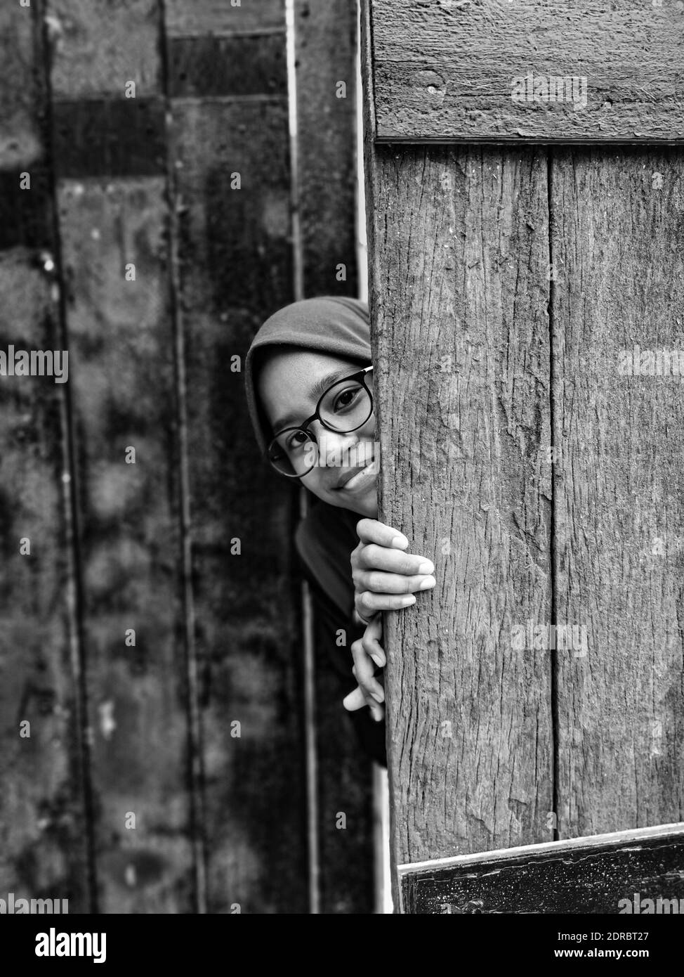 Girl peeking door Black and White Stock Photos & Images - Alamy