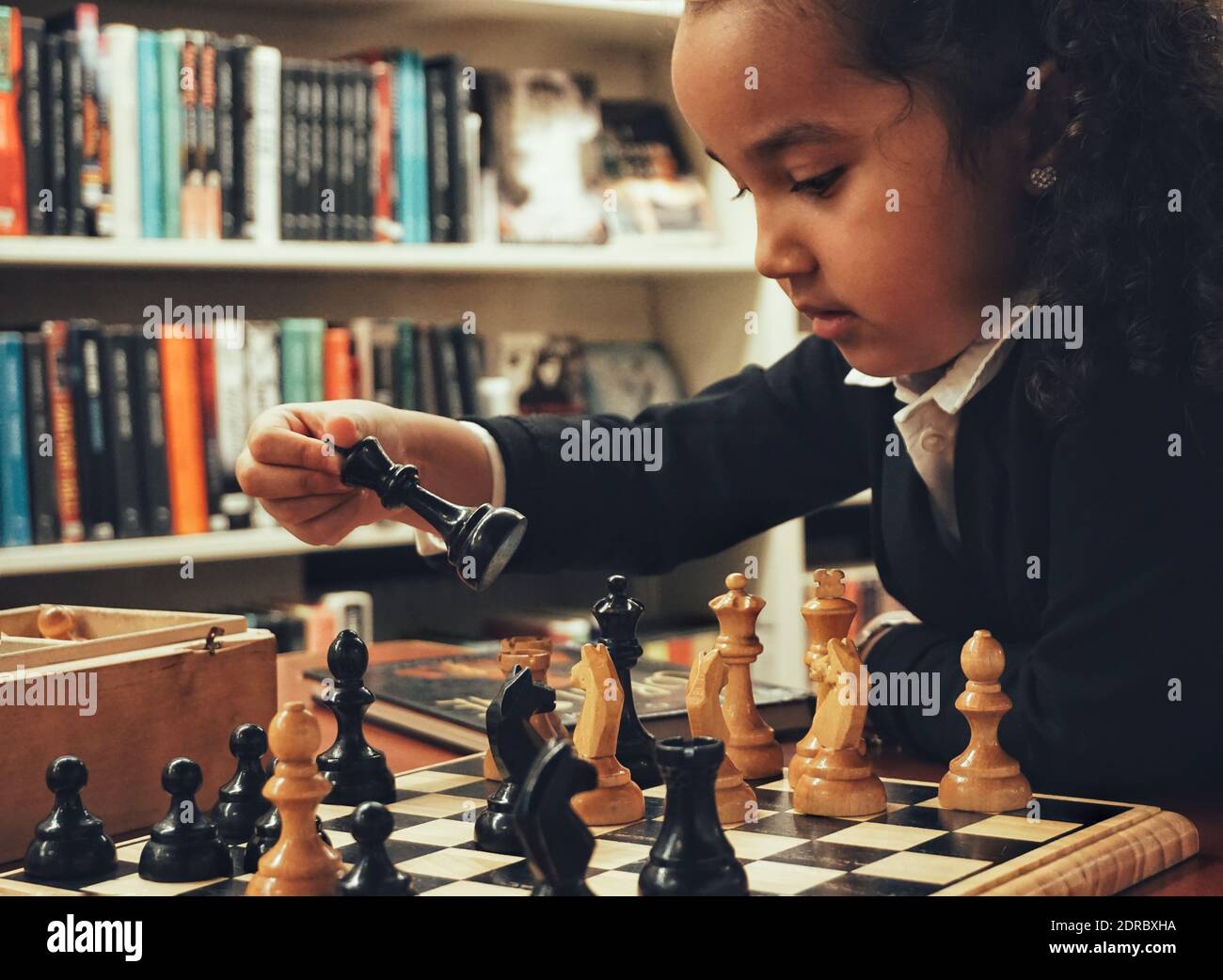 Asian girl playing chess hi-res stock photography and images - Alamy