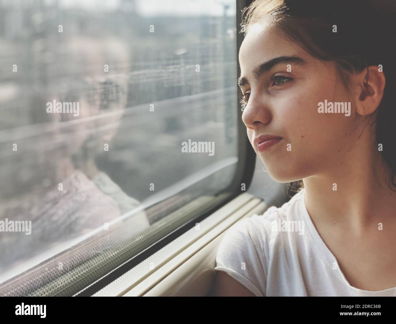 Woman Looking Through Window Sitting In Train Stock Photo - Alamy