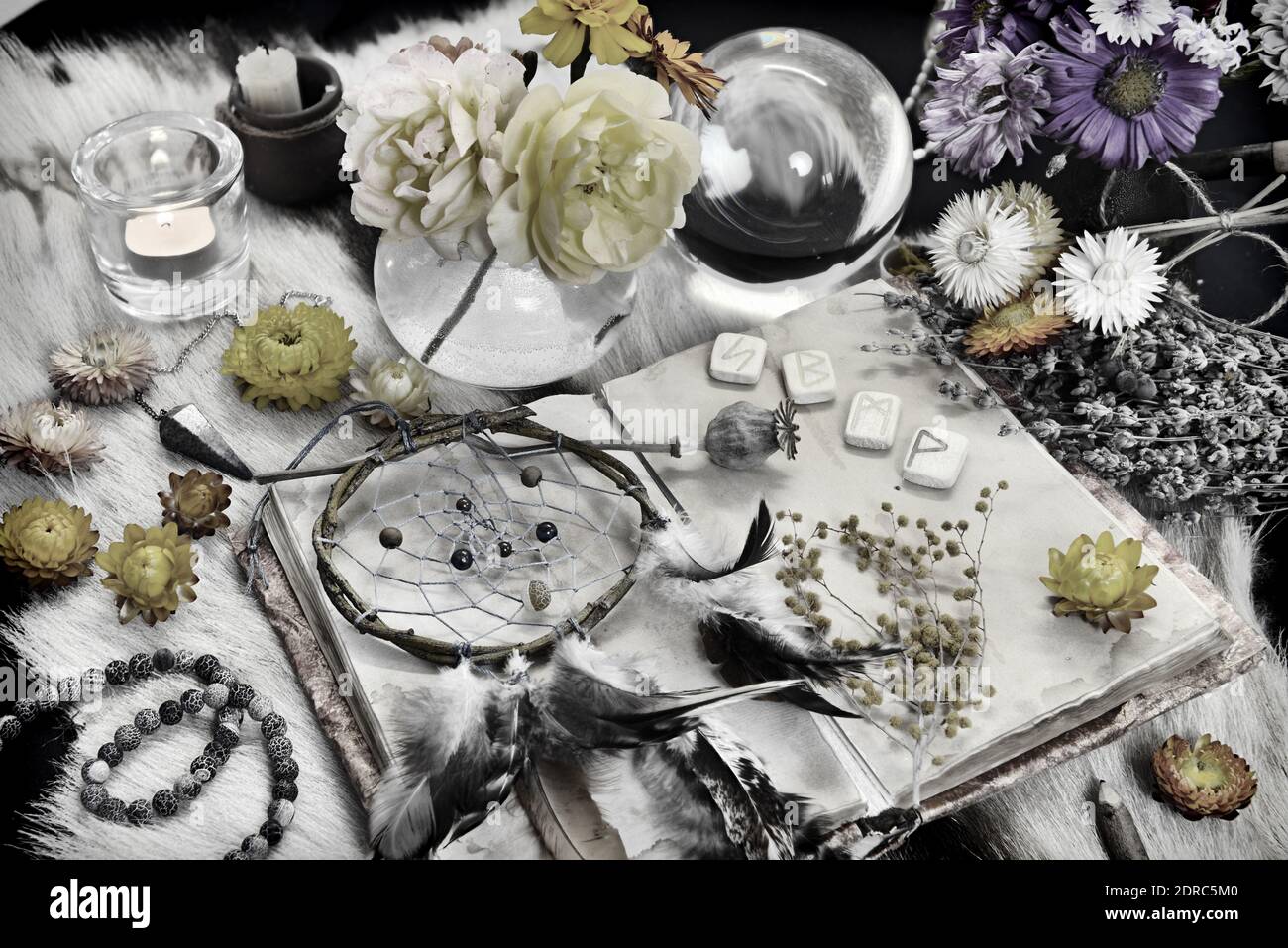 Styled still life with old diary book, runes, dreamcatcher, candle and ...