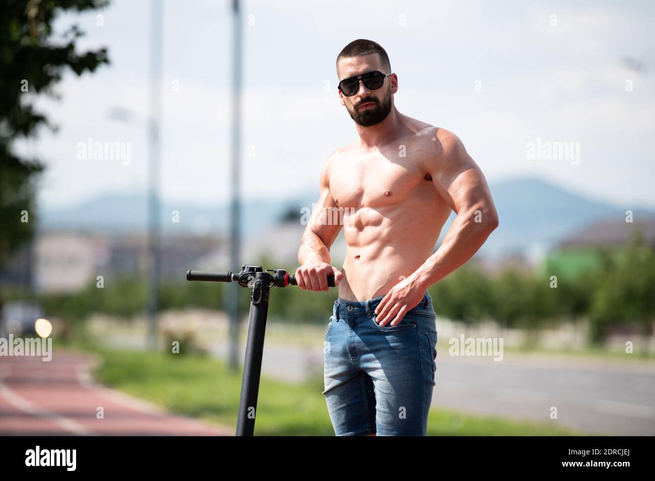 Young Attractive Athlete Resting After Driving His Scooter on the ...