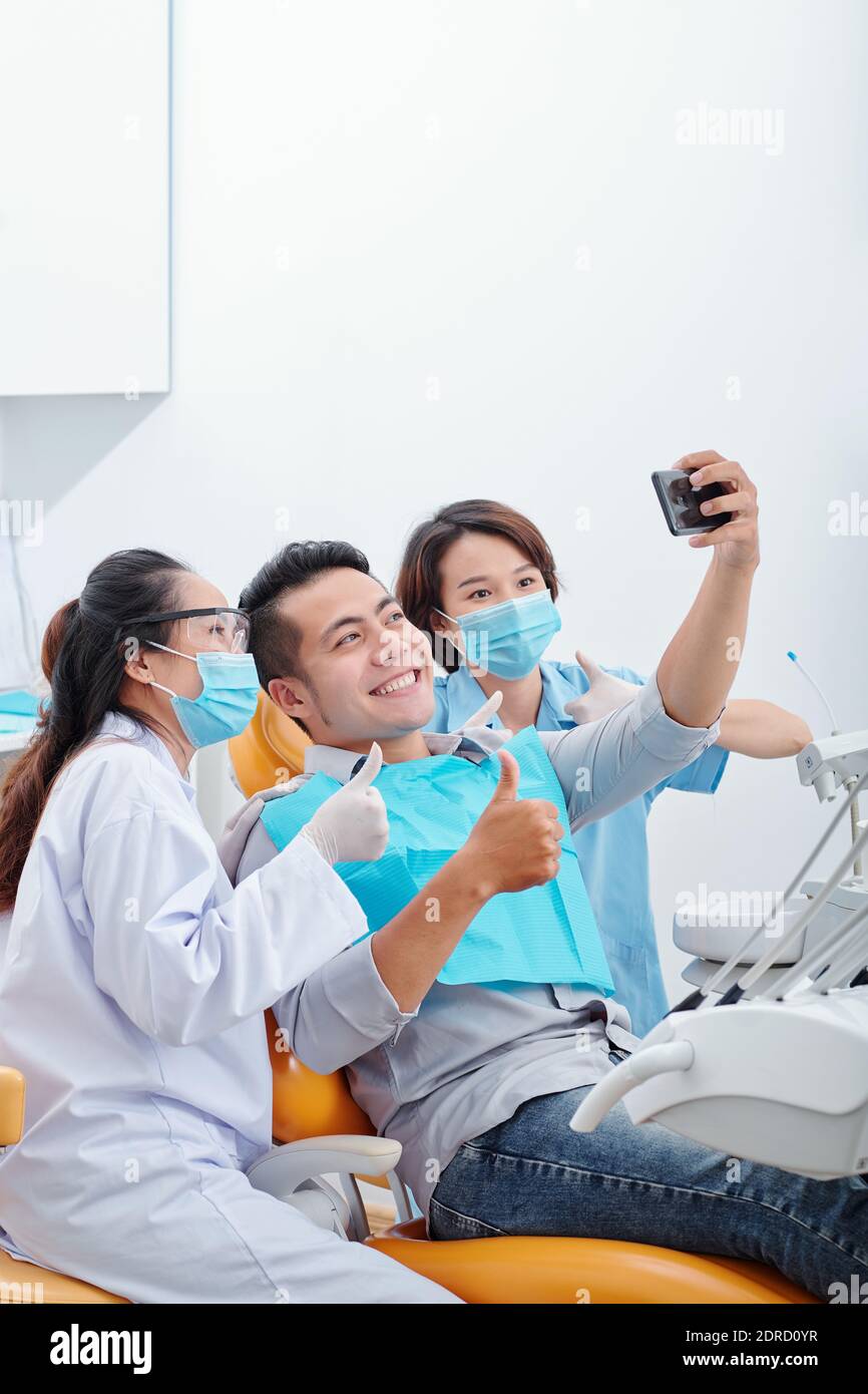 Patient photographing with dentists Stock Photo - Alamy