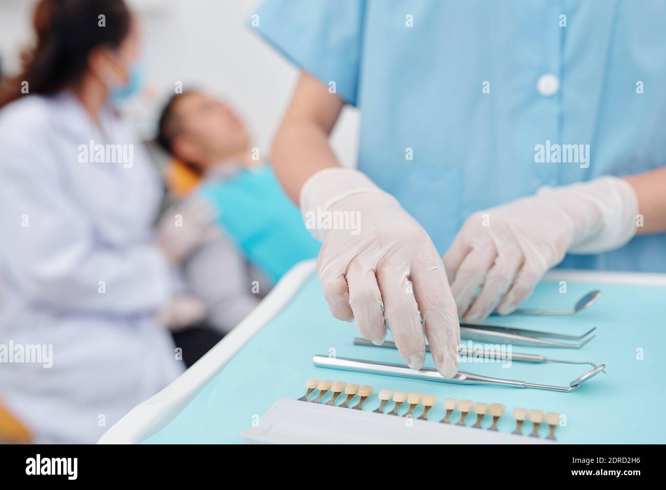 Dentist assistant putting tools on tray Stock Photo - Alamy