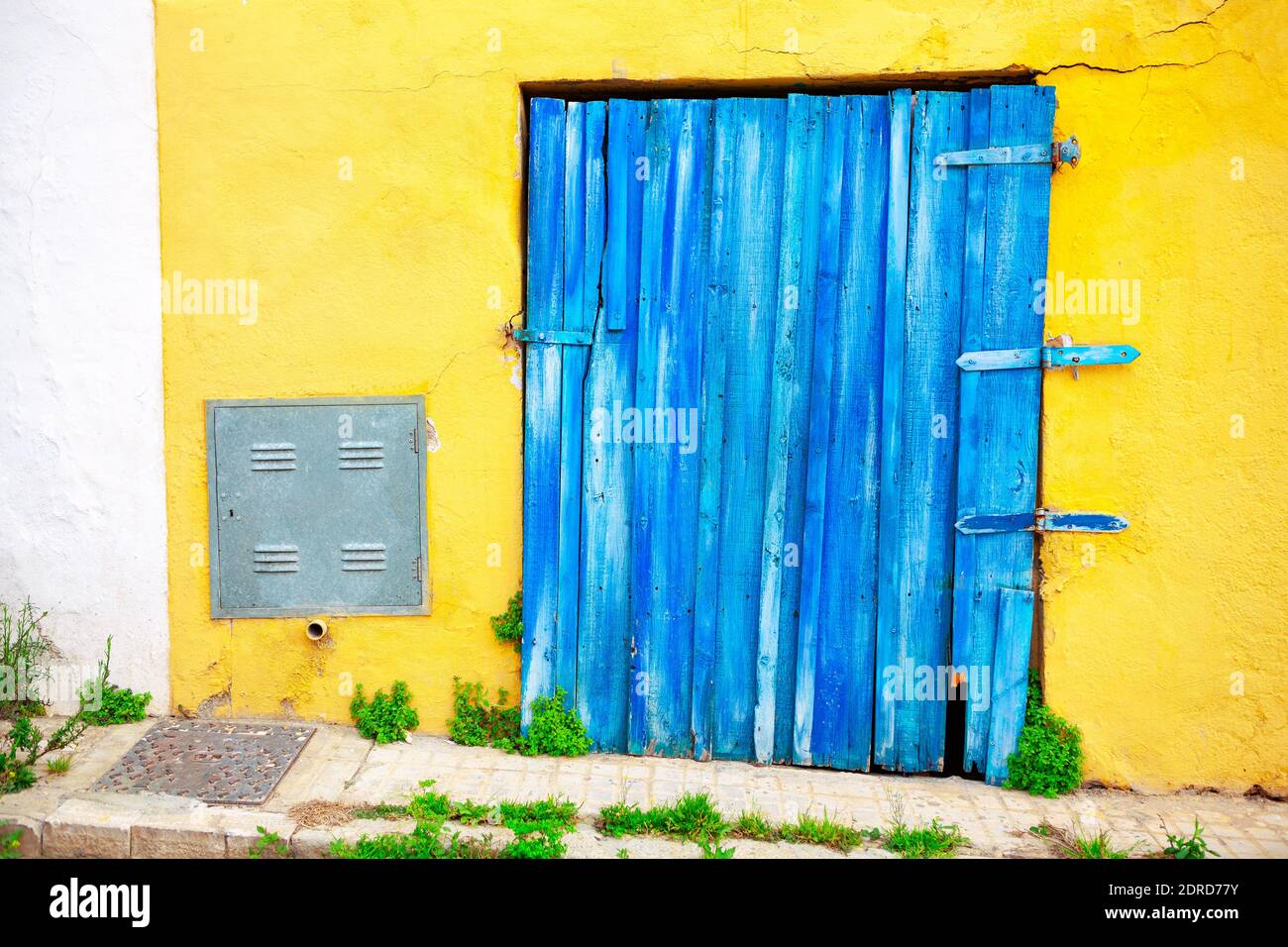 Rustic blue door and yellow wall . Rural wooden door . Colorful village ...