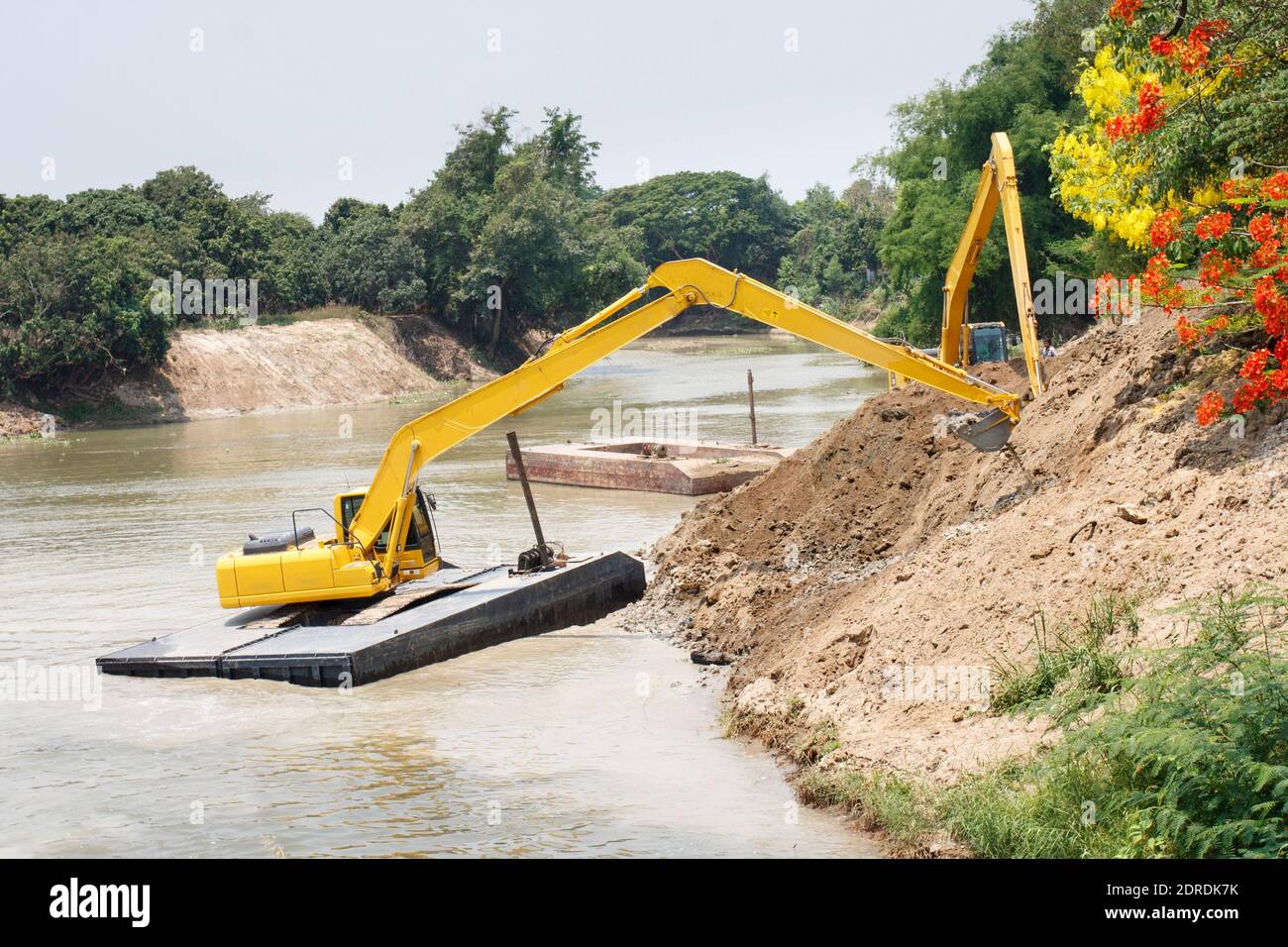 excavator machine group works at river for protect flood Stock Photo ...