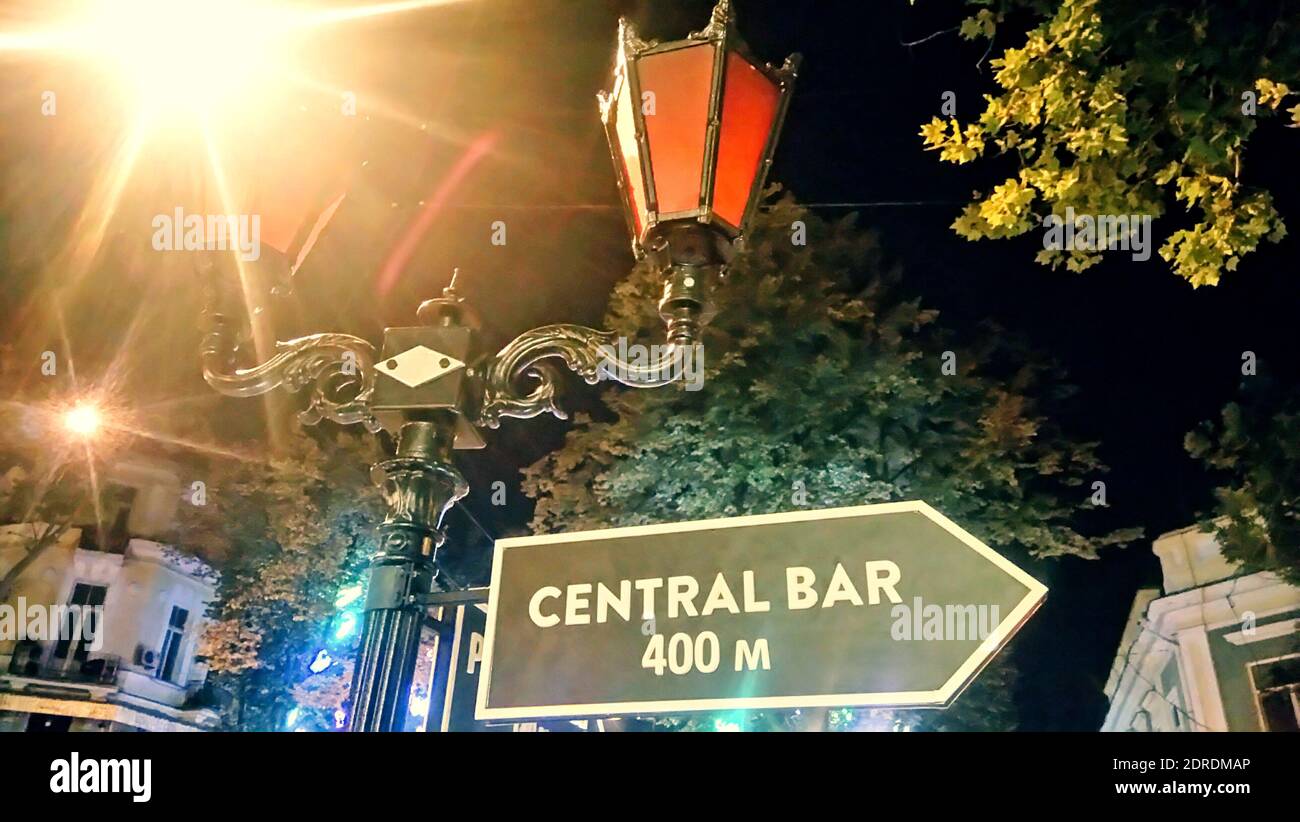 Ancient street lamp and pointer towards the pub at night Stock Photo ...
