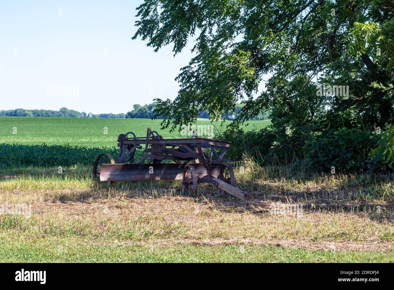 Close up landscape view of a vintage tractor drawn road grader farm ...