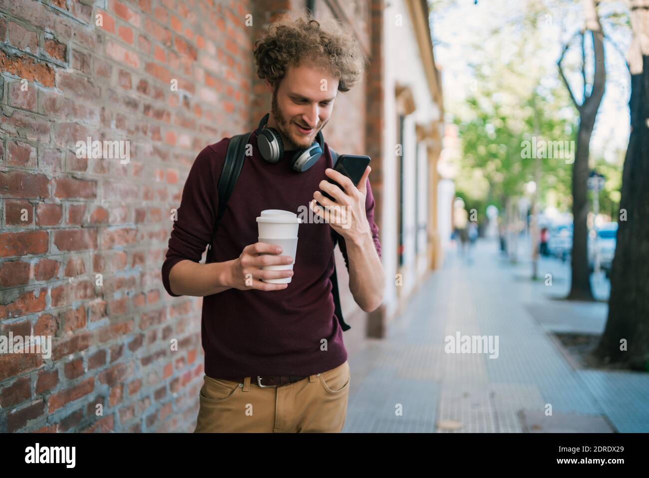 Young man using his mobile phone Stock Photo - Alamy