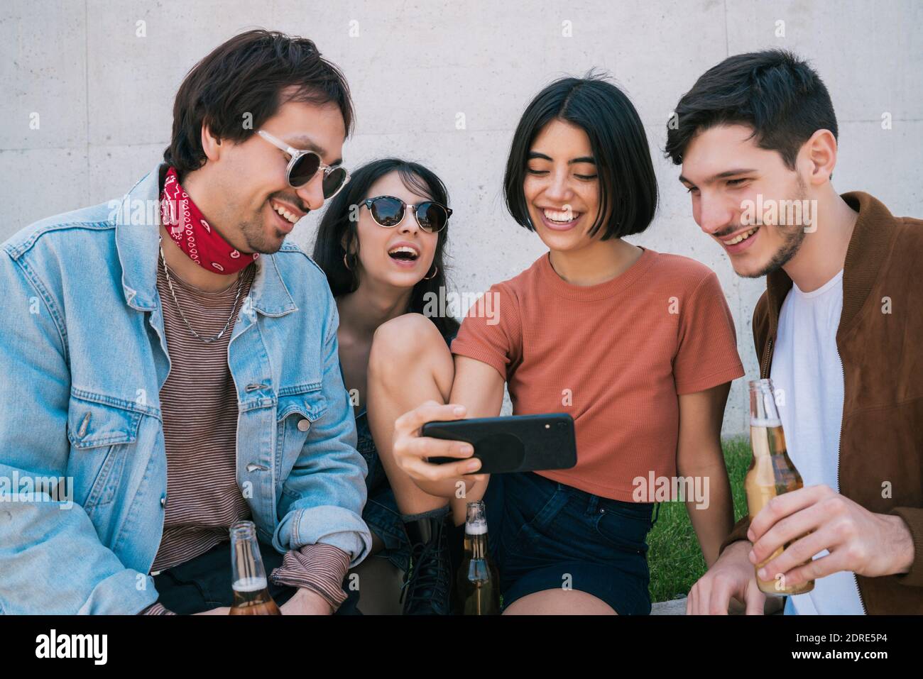 Group of friends watching something in smartphone Stock Photo - Alamy