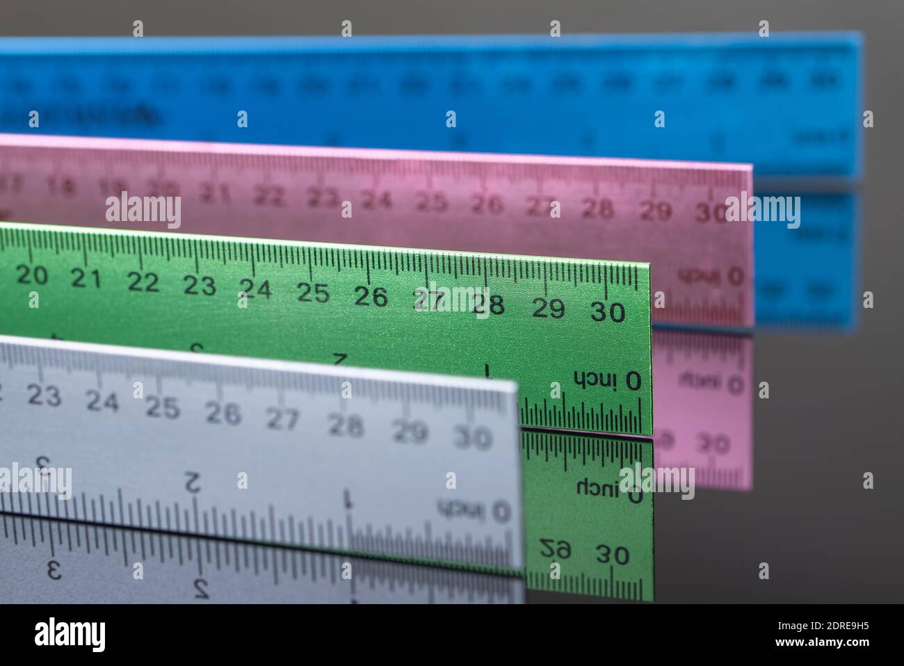 Workshop colored metal rulers on black glass table Stock Photo - Alamy