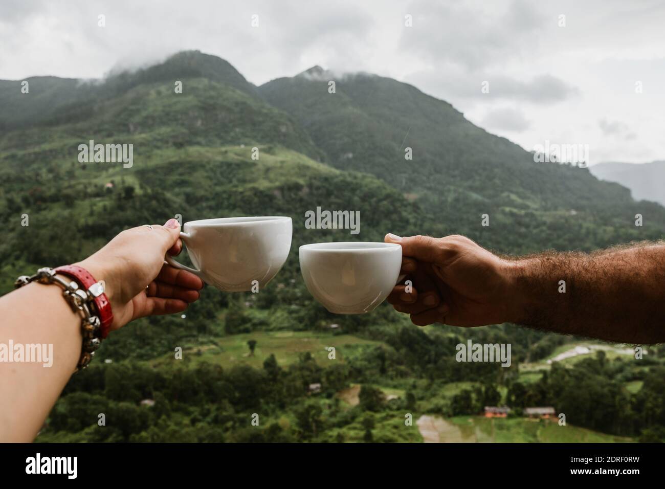 Hands toasting cups High Resolution Stock Photography and Images - Alamy