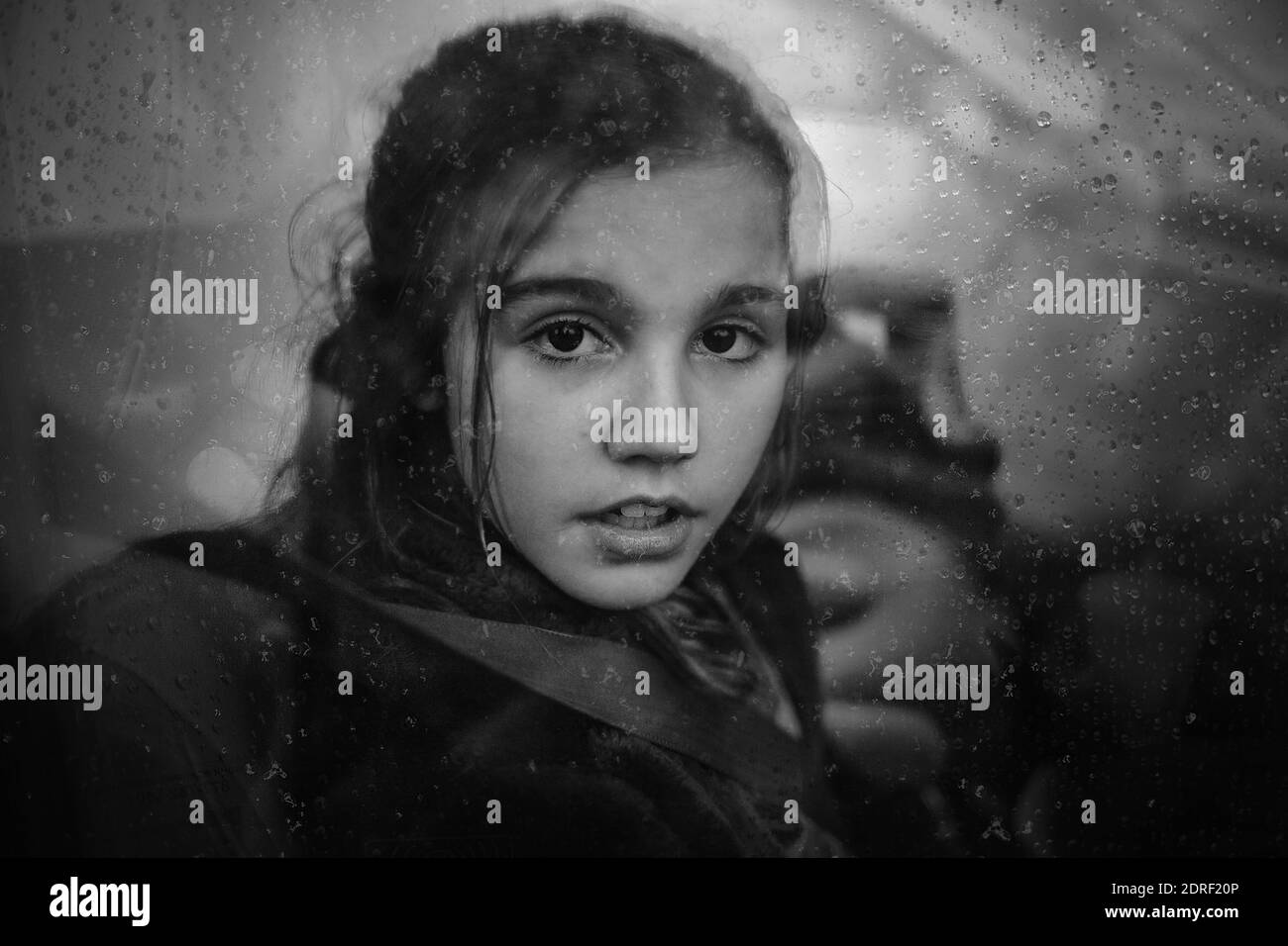 Girl looking through glass front Black and White Stock Photos & Images ...