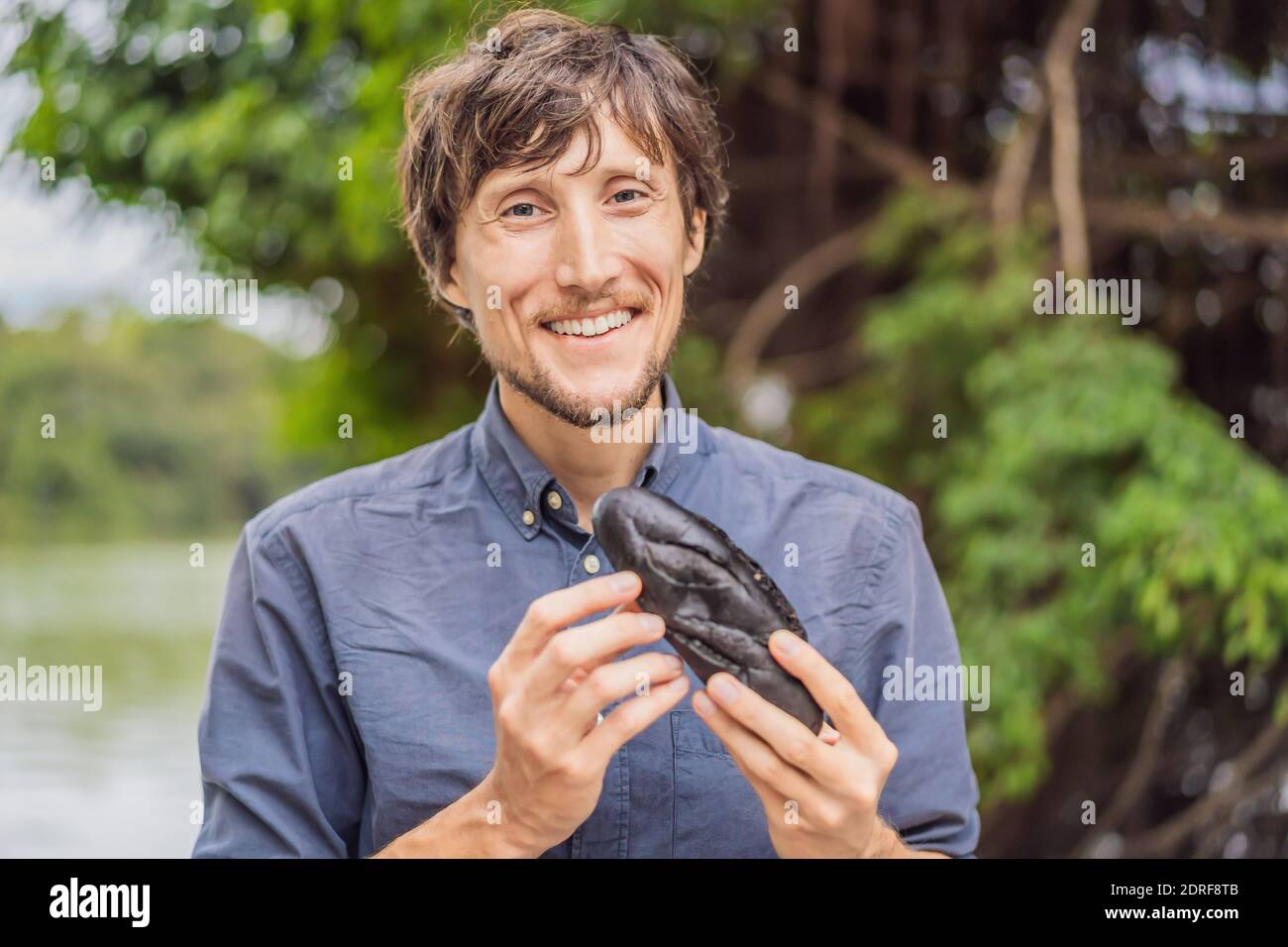 Man eating Vietnamese Pork Banh Mi Sandwich in a black baguette Stock ...