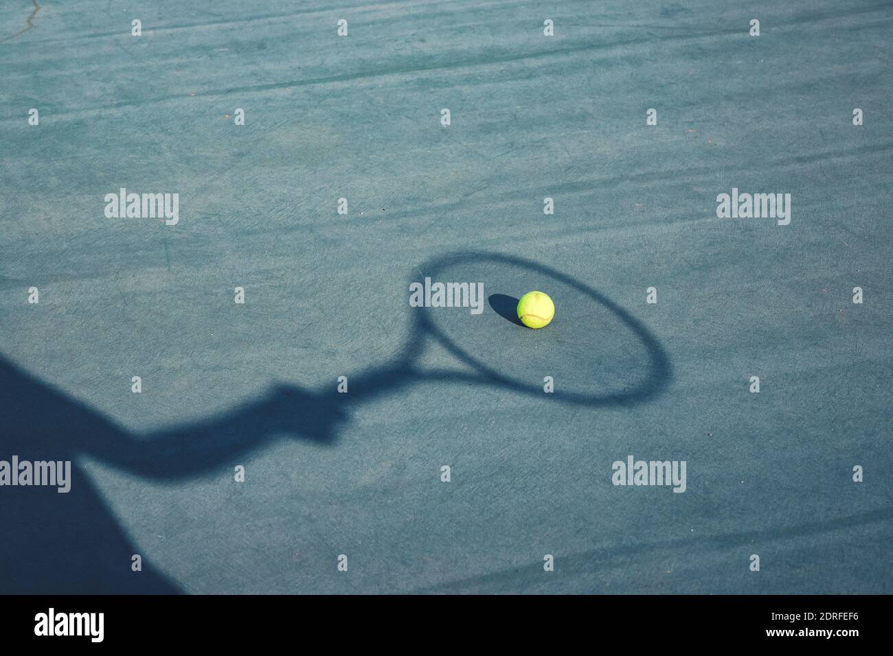 An amazing shot of a tennis ball on the pitch with the shadow of a hand ...