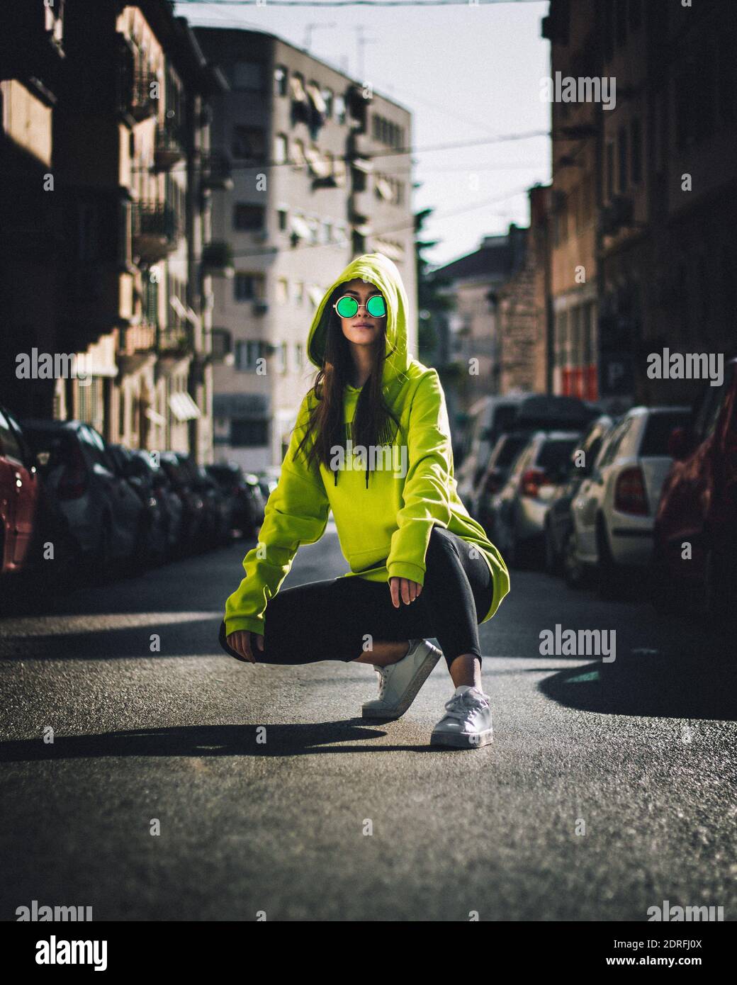 Young woman crouching car portrait hi-res stock photography and images ...