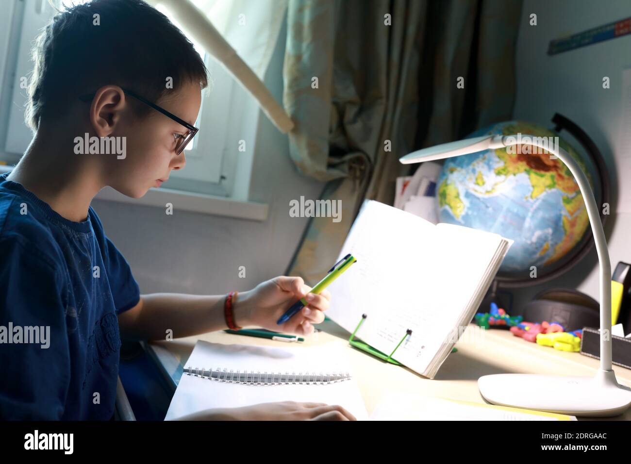 Boy doing homework at desk at home Stock Photo - Alamy