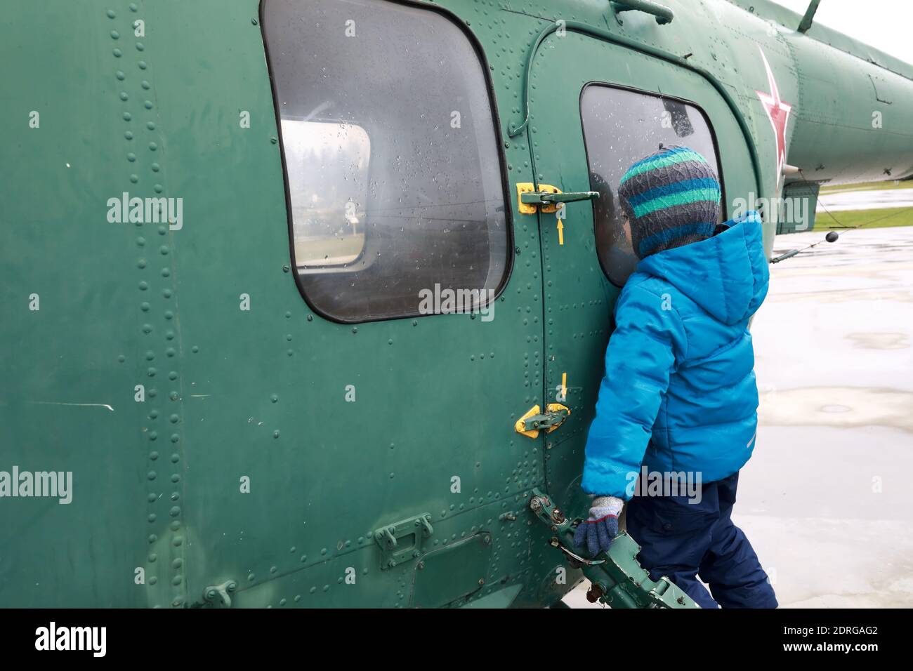 Child looking out window of military helicopter Hoplite, Russia Stock ...