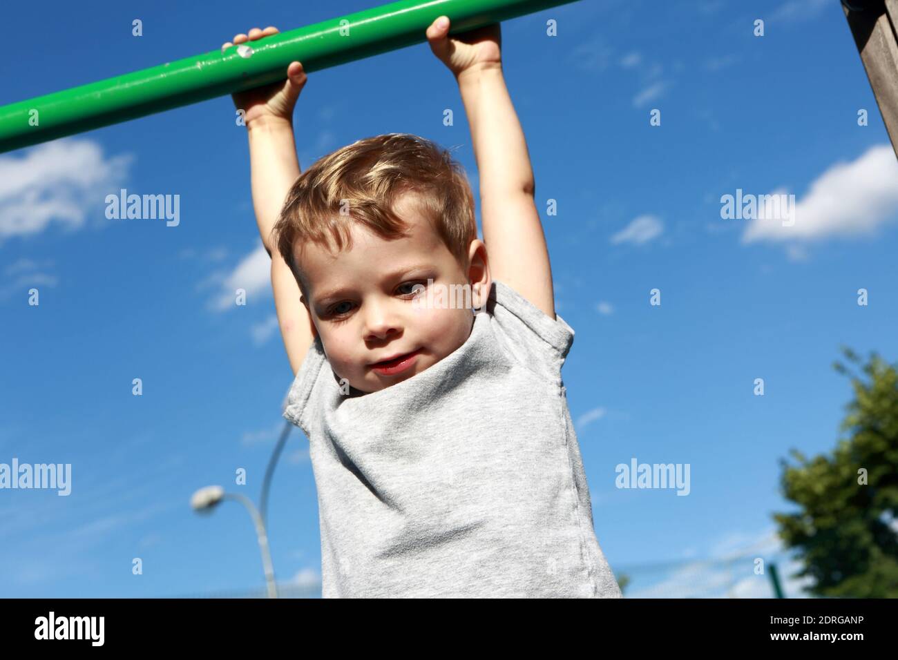 Portrait of a child on horizontal bar Stock Photo - Alamy