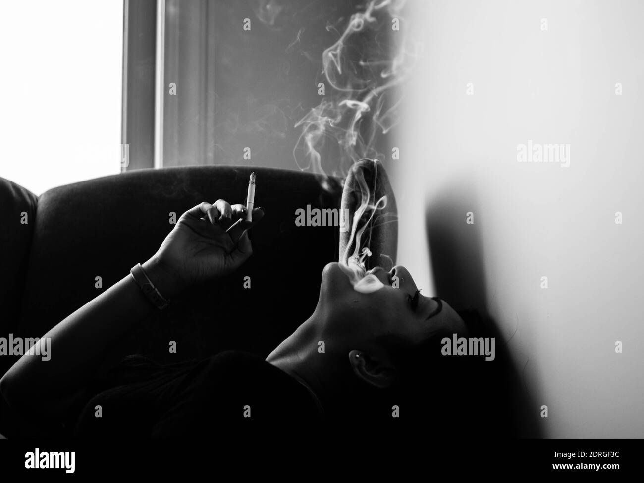 Woman Lying Down Smoking Cigarette High Resolution Stock Photography ...