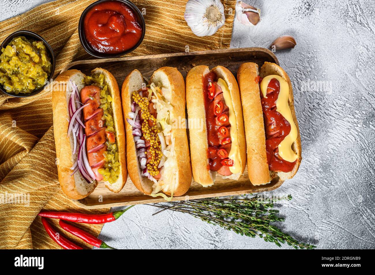 Hot dogs fully loaded with assorted toppings on a tray. Delicious hot ...